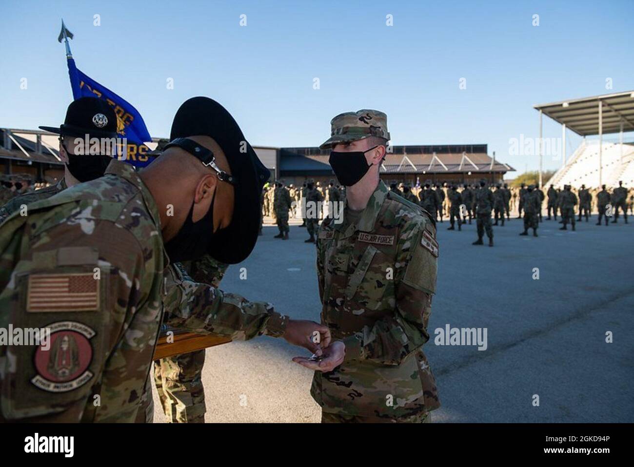 A Military Training Instructor presents the Airman’s coin during ...