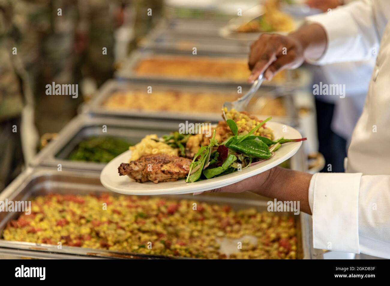 A culinary specialist prepares a plate of food during the “Back 2 ...