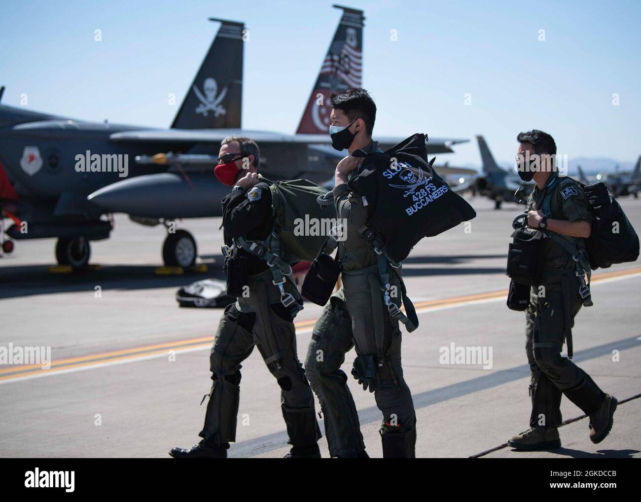 A Republic of Singapore Air Force contractor and RSAF pilots, walk down ...