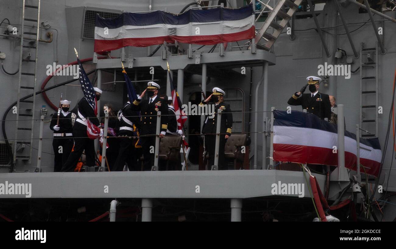 Capt. Corey Keniston, left, and Capt. Megan Thomas salute the Color ...