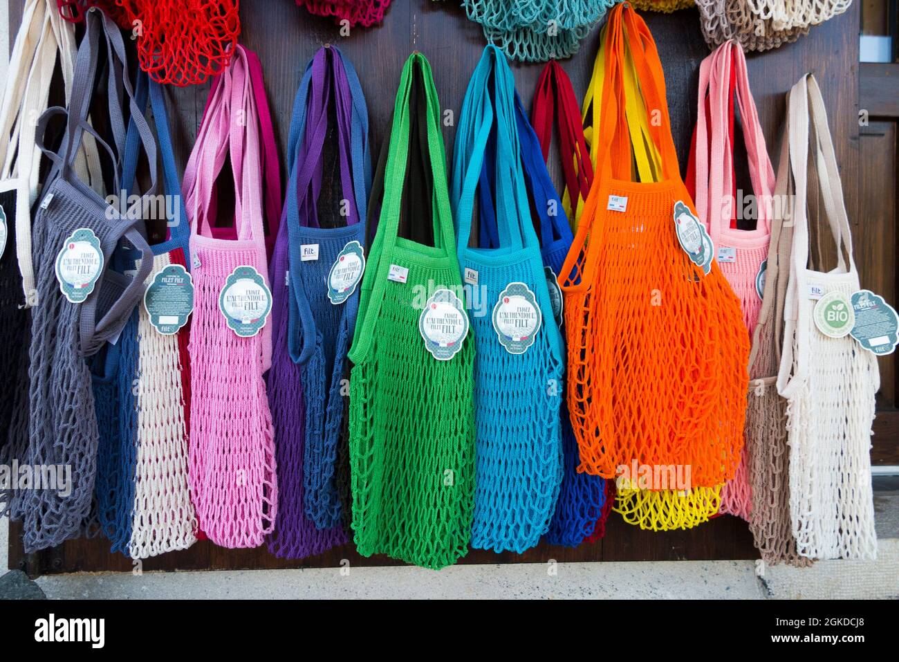 A range of string shopping bags in numerous colours but all of a ...