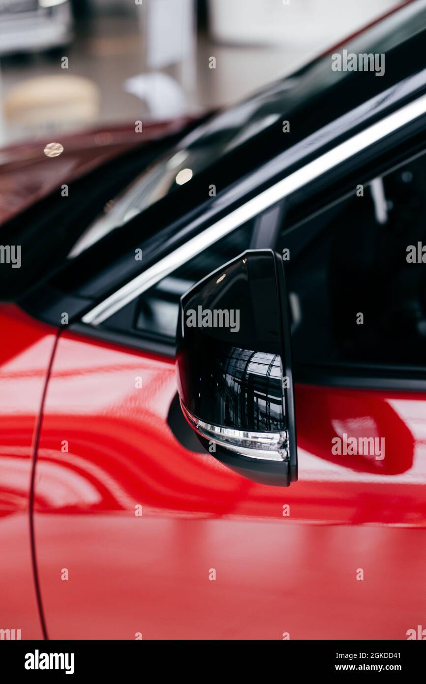 Side view of turning luxury red car Stock Photo - Alamy