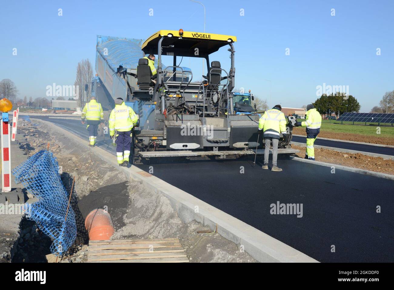 Contractors with Belgian construction firm WANTY operate an asphalt ...