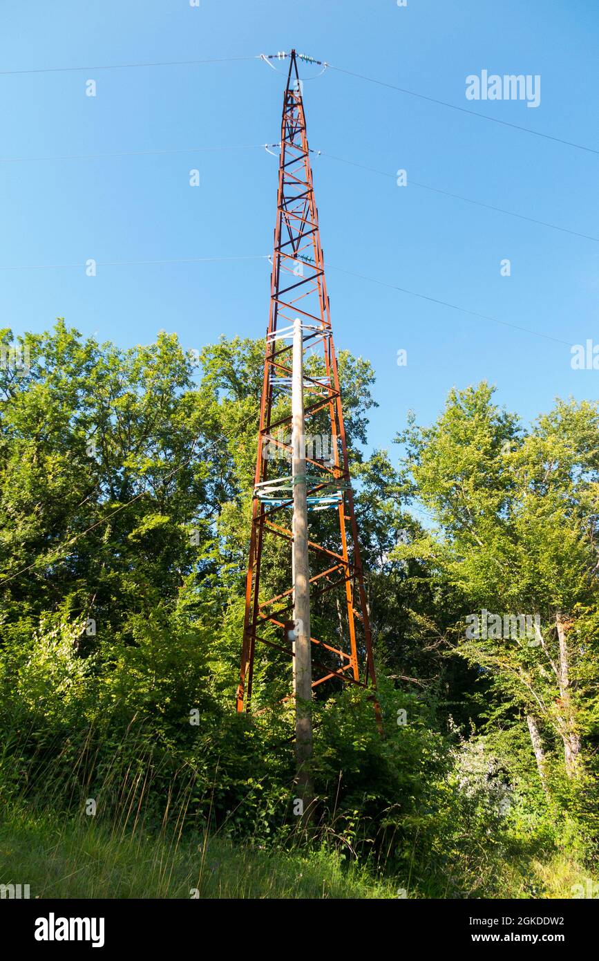 Rather elderly electricity pylon strengthened with wooden tree trunk ...