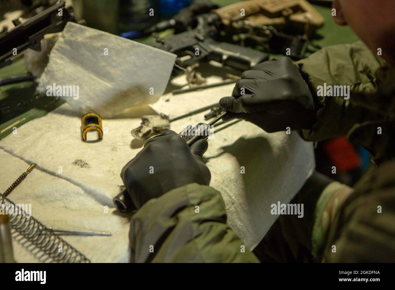 Dutch Marine 1st Sgt. Eric with 32nd Raiding Squadron cleans the bolt ...