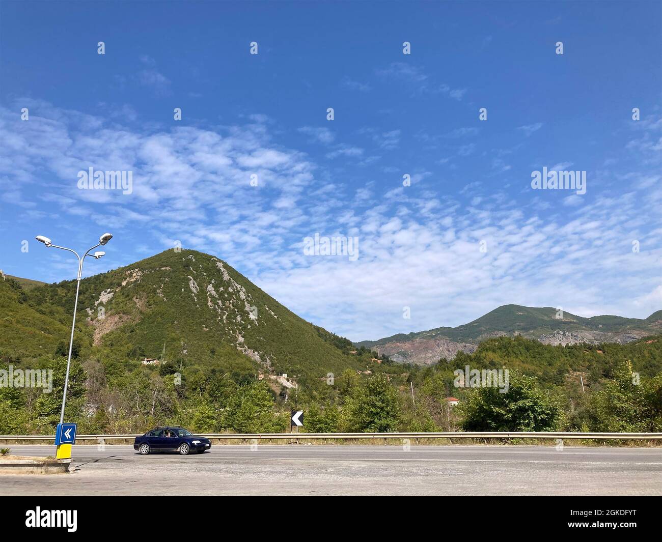 car with travelers driving on mountain highway Stock Photo - Alamy