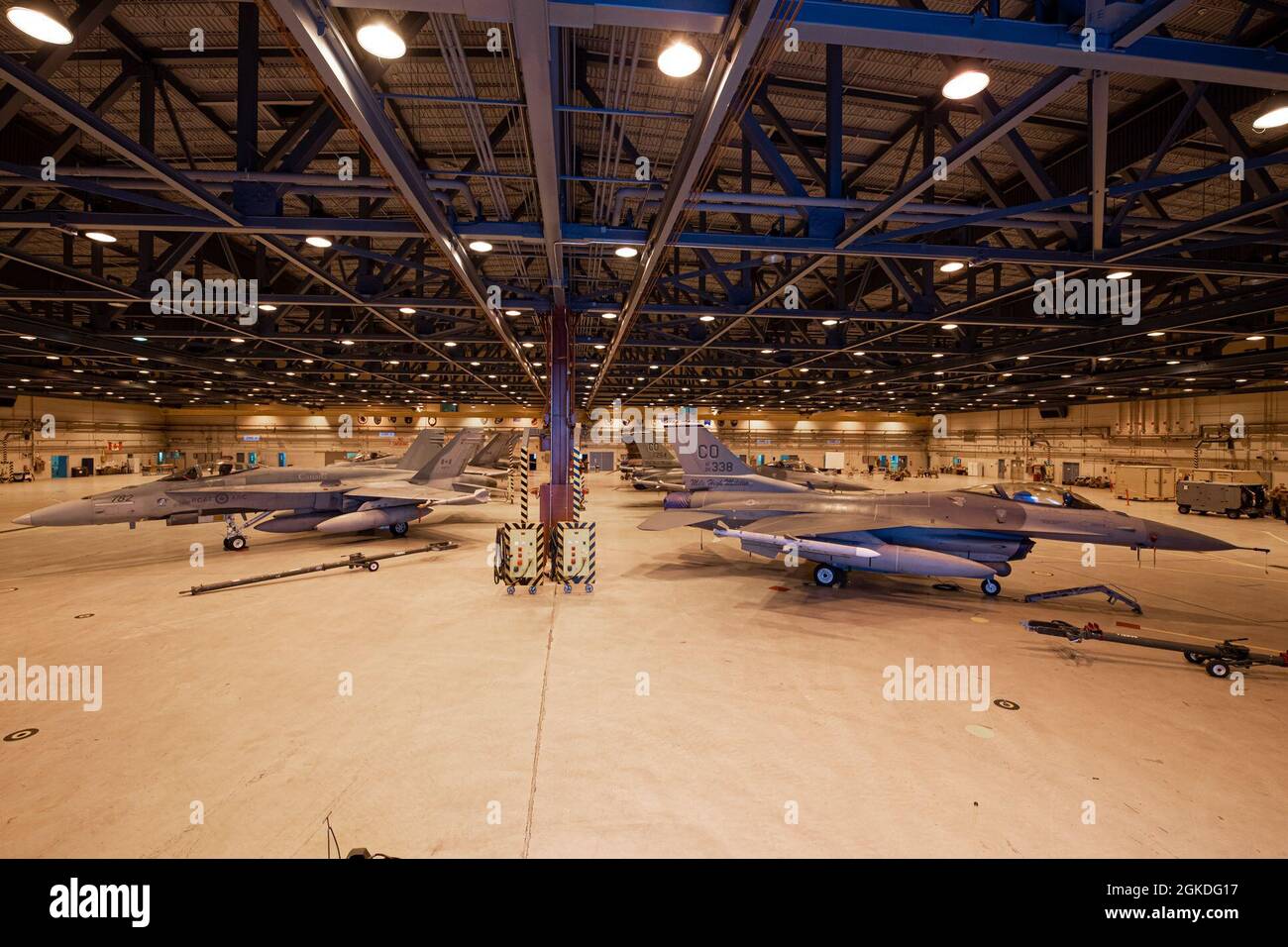 Canadian CF-18s and American F-16 Fighter Jets are housed together in a ...