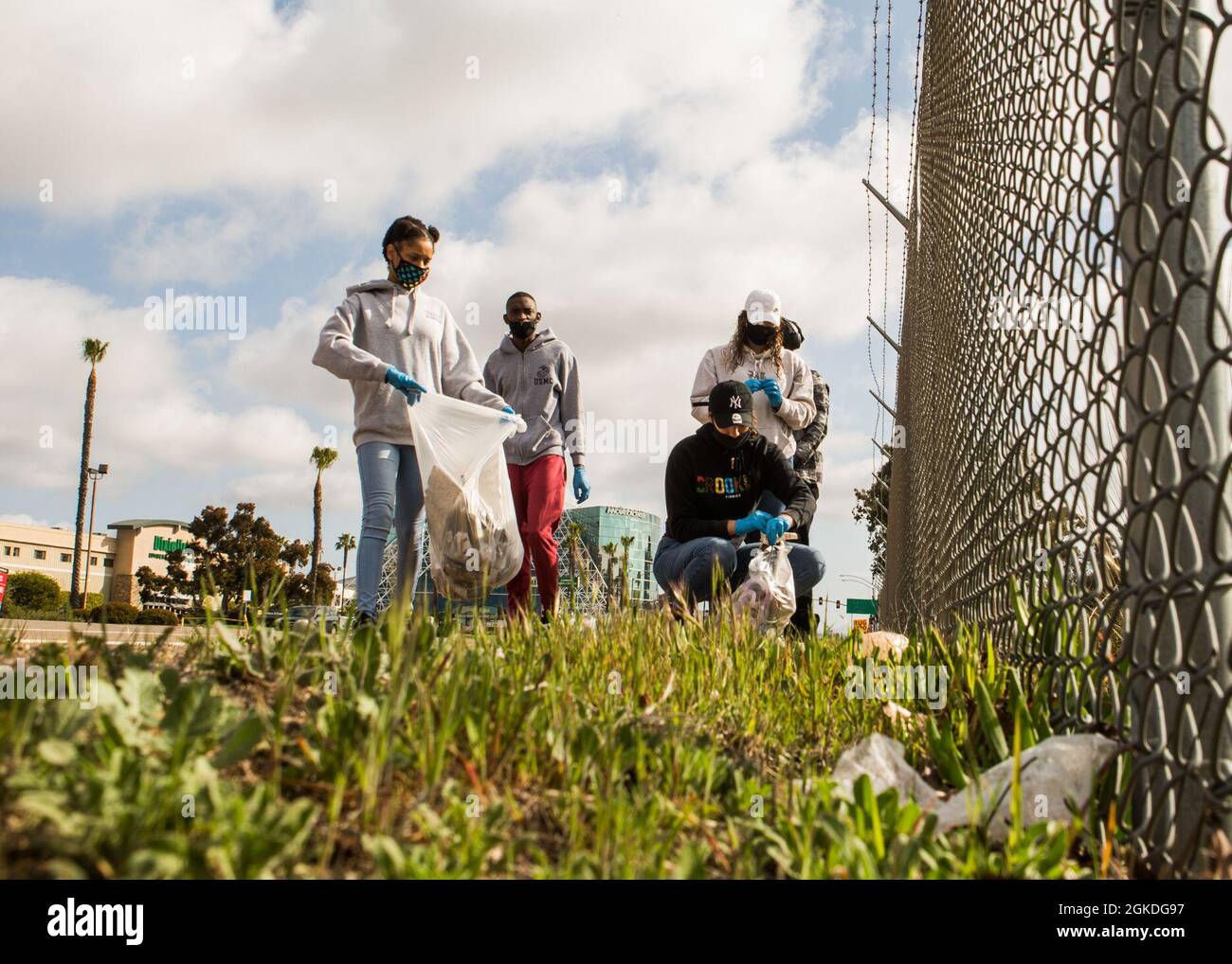 U.S. Marines volunteering for the Single Marine Program pick up trash ...