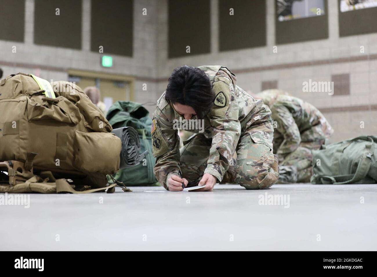 1st Sgt. Tina Semanoff from 97th Troop Command, fills out a ...