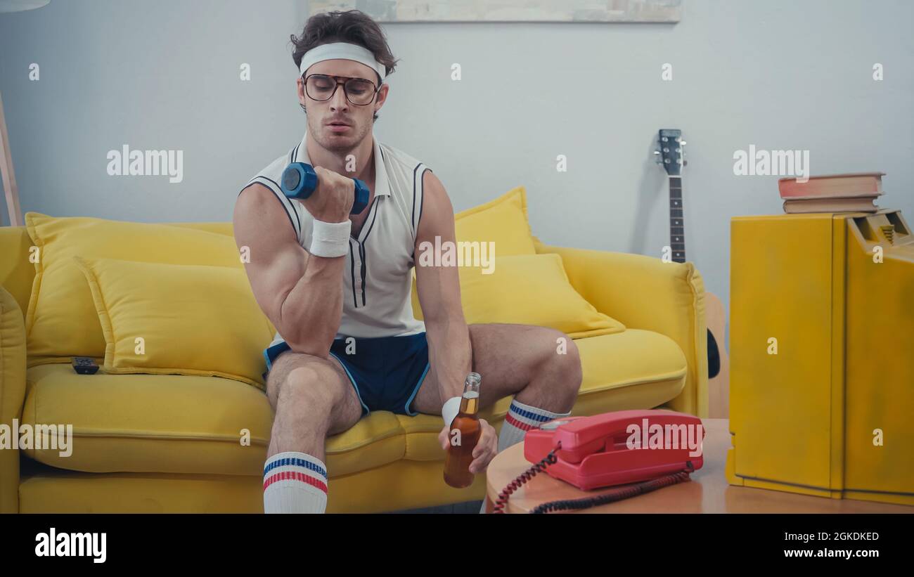 Man lifting dumbbell sitting on hi-res stock photography and images - Alamy