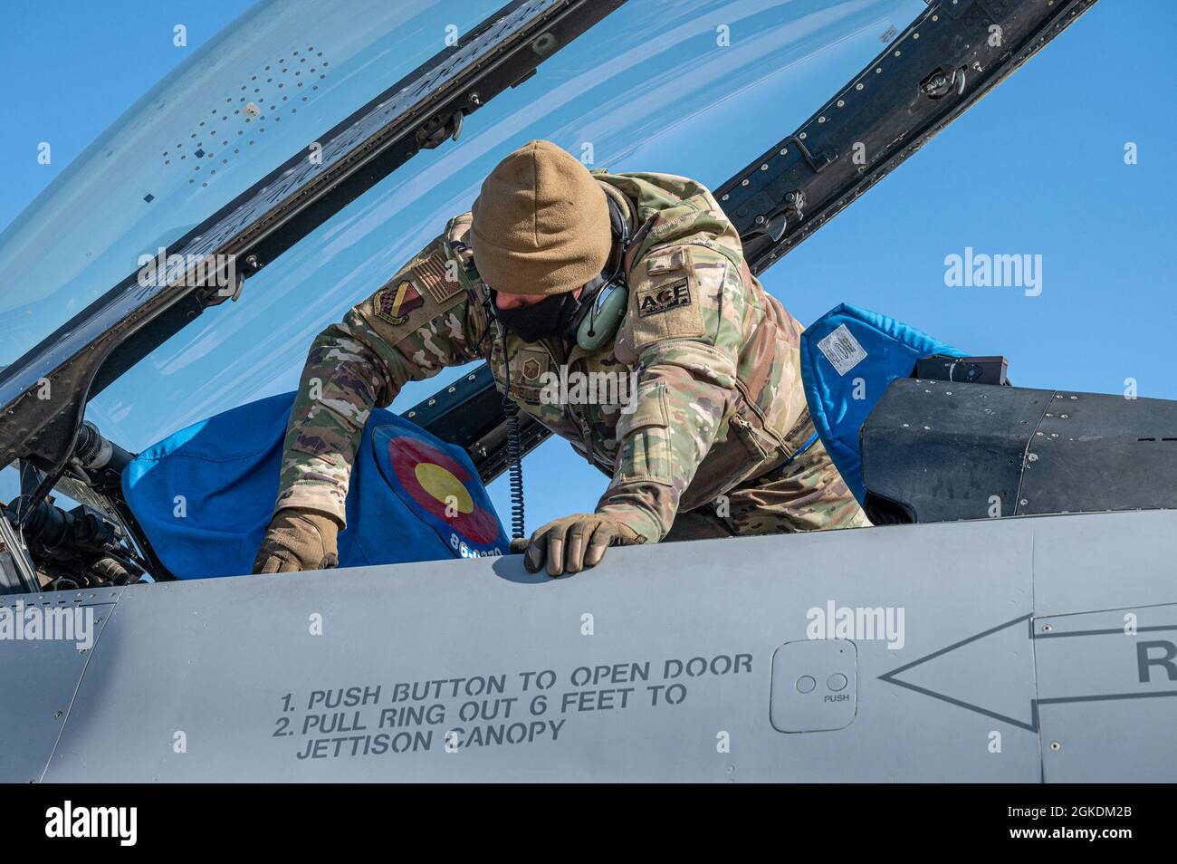 U.S. Air Force Master Sergeant Kelsey installs a seat guard on the F-16 ...