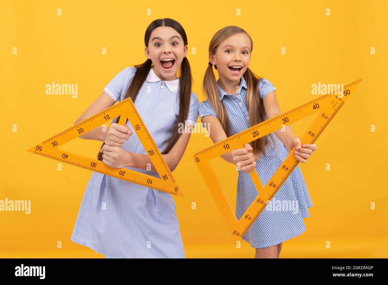Learn what angles are. Happy teen girls hold triangular rulers ...