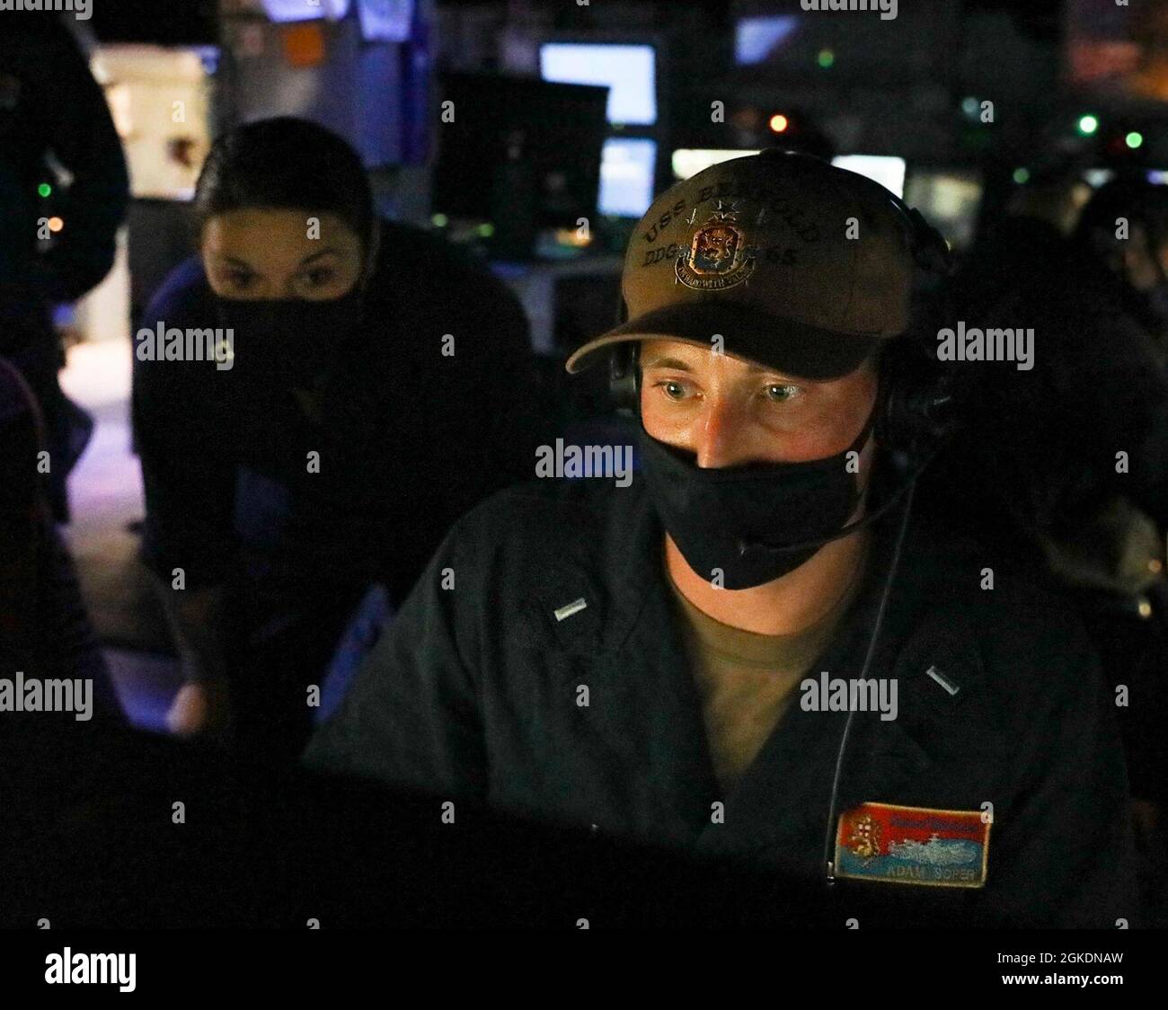 Lt.j.g. Adam Soper stands watch in the combat information center aboard ...