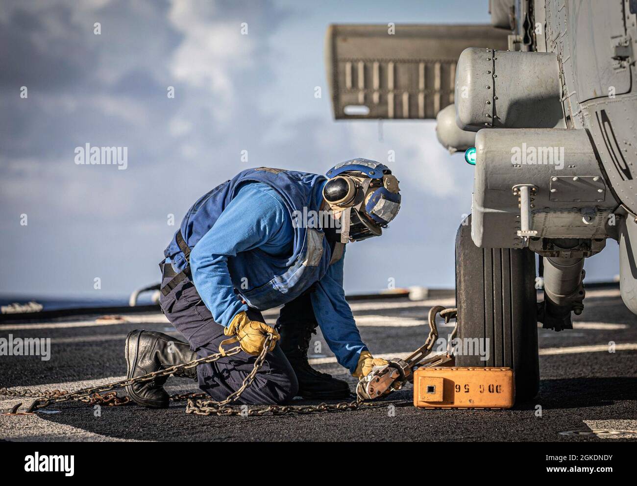 Seaman Leo Cerillo, from Indio, Calif., attaches chocks and chains to ...