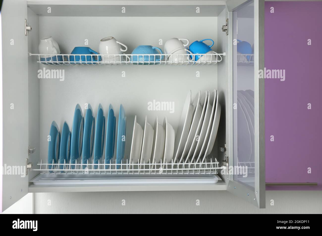 Set of white and blue tableware on drying rack in kitchen Stock Photo ...