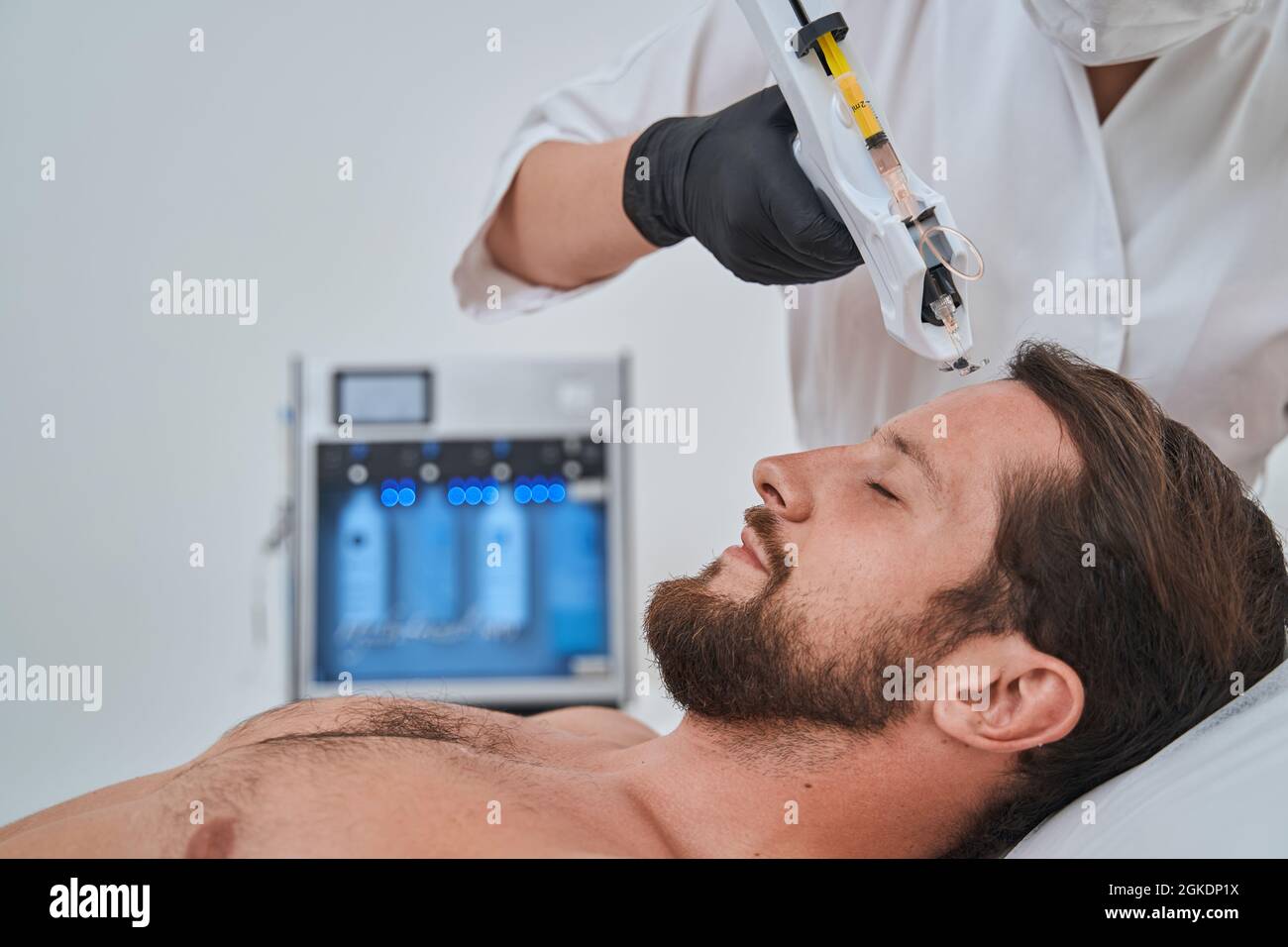 Patient getting a subcutaneous injection into his forehead with a ...