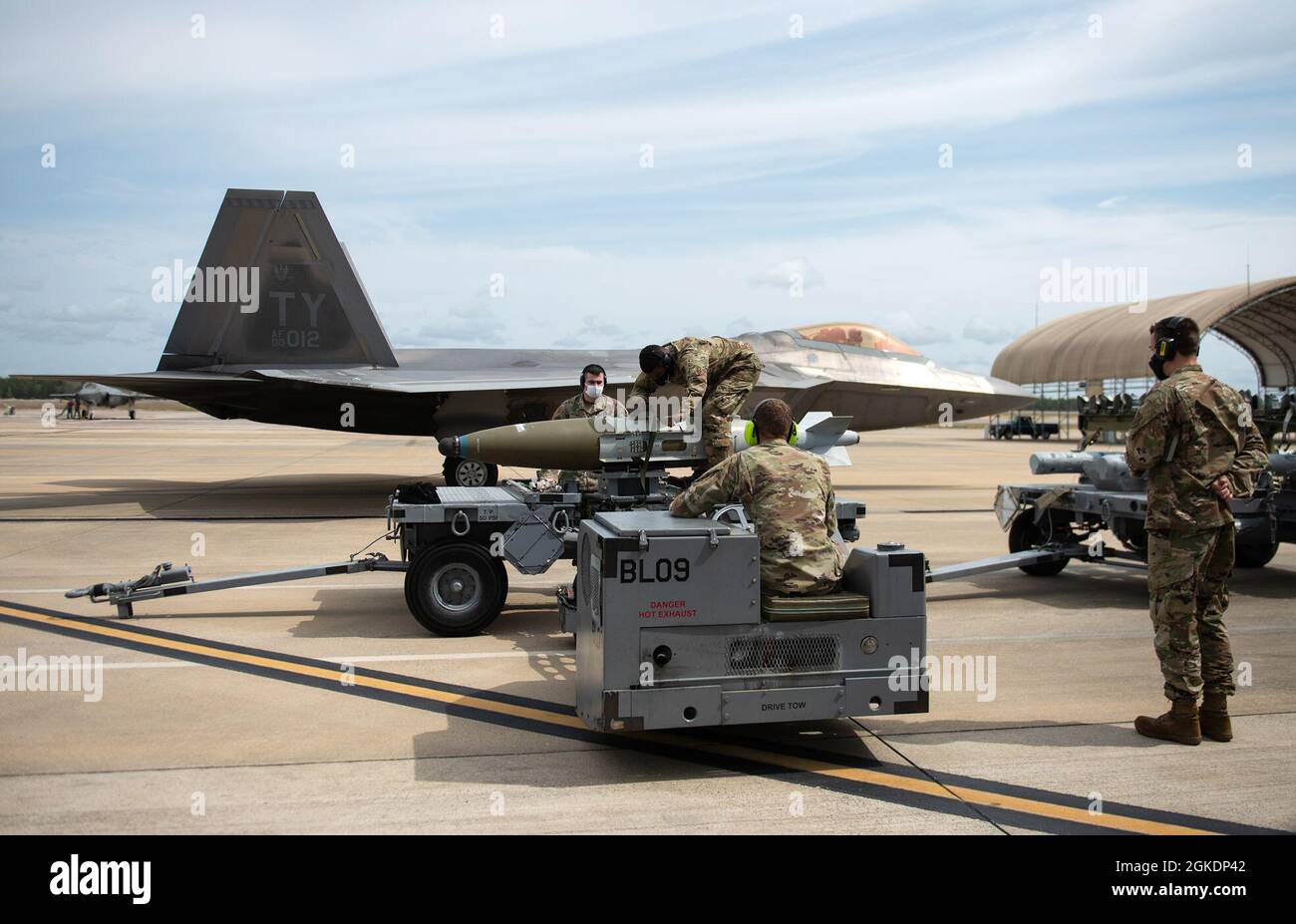 A 325th Aircraft Maintenance Squadron team prepares to move a GBU-32 ...