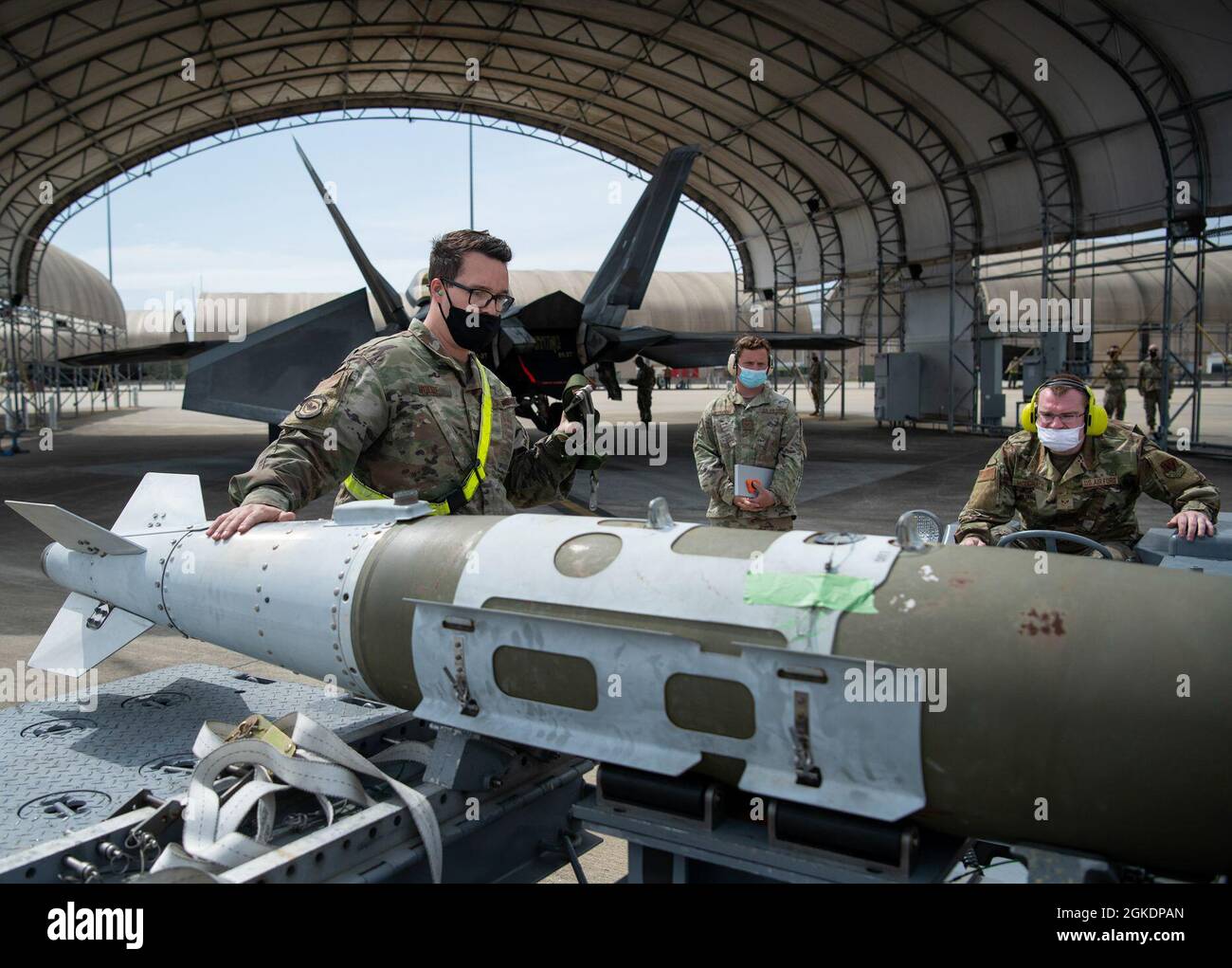 A 325th Aircraft Maintenance Squadron loadcrew lifts a GBU-32 during ...