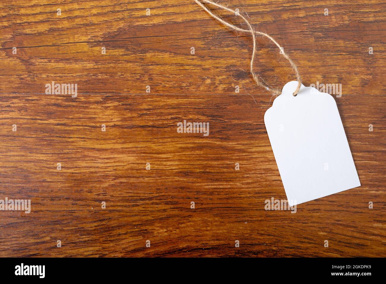 Composition of white label card with copy space on wooden background ...
