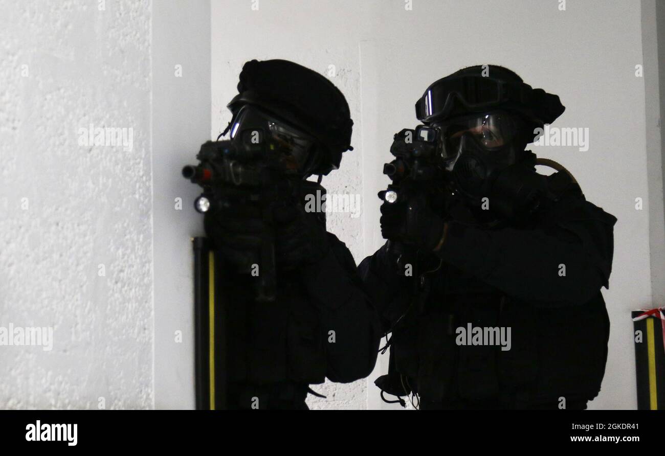 Qatari Special Forces secure a corner before entering a room in a ...