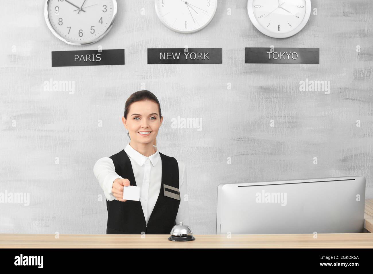 Female receptionist with key card from apartment in hotel Stock Photo ...