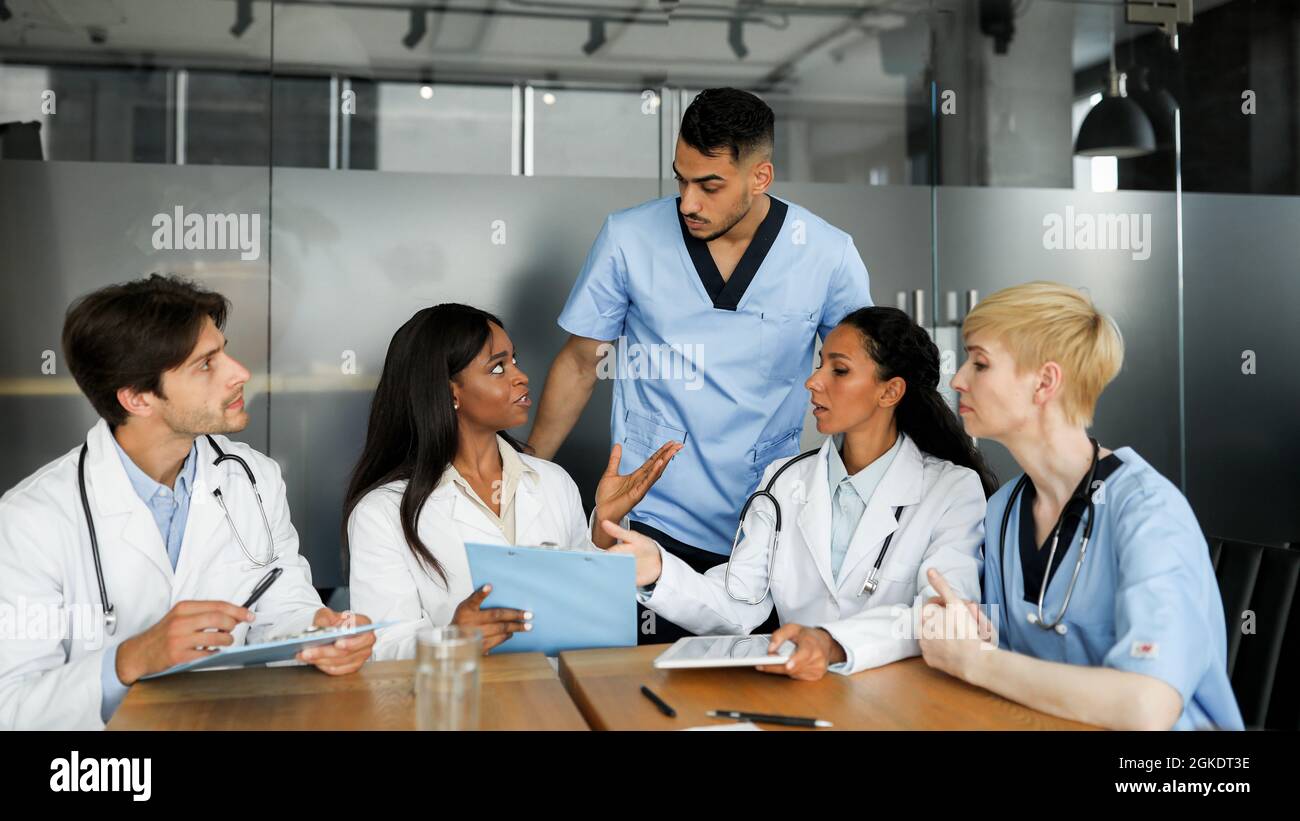 Concentrated multiracial group of doctors having consultation Stock ...
