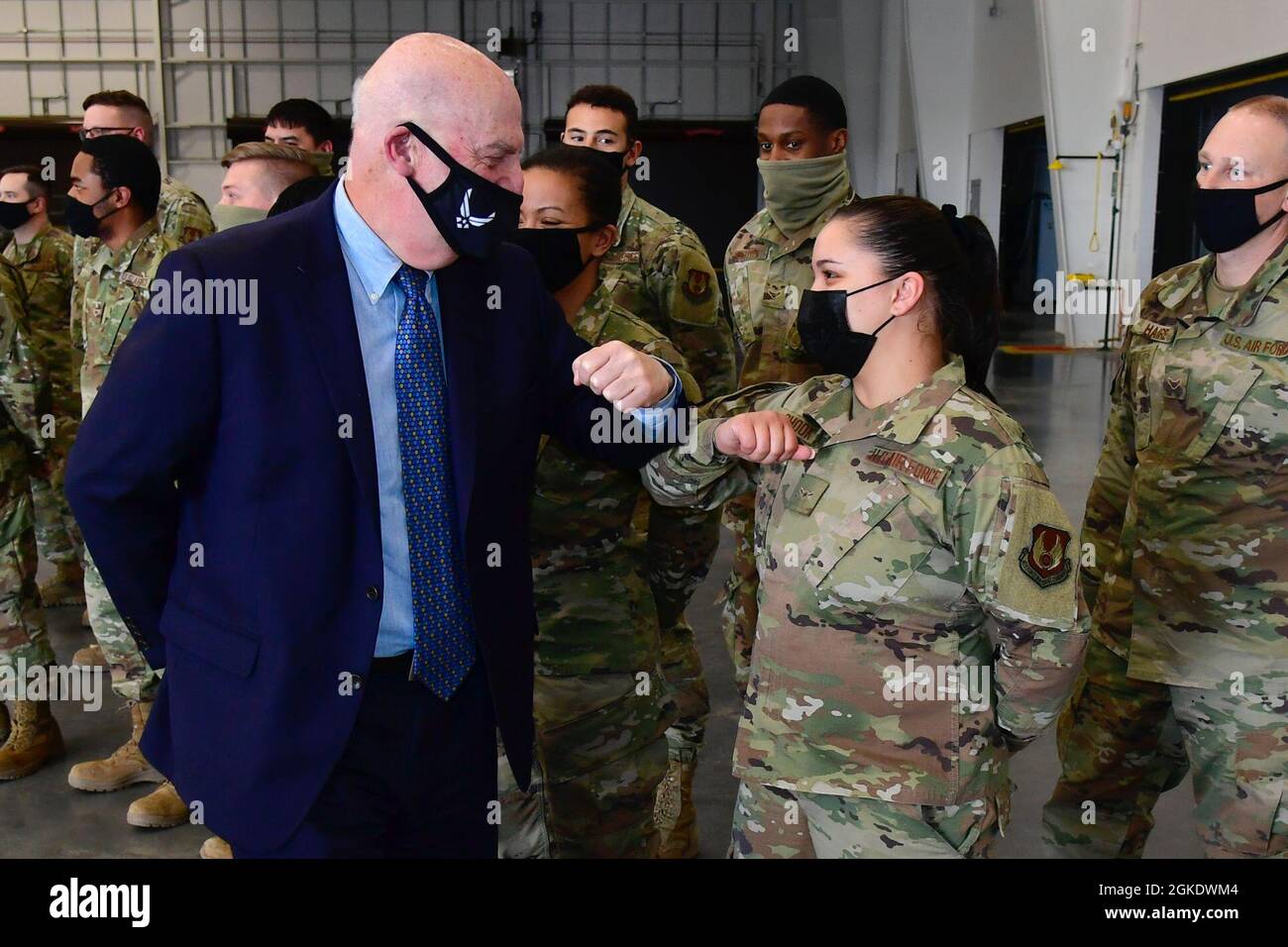 Acting Secretary of the Air Force John Roth exchanges an elbow bumps ...