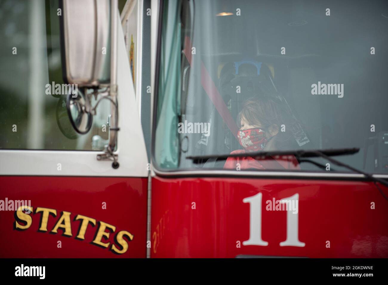 A child at the 4th Logistic Readiness Squadron Kids Day event sits ...
