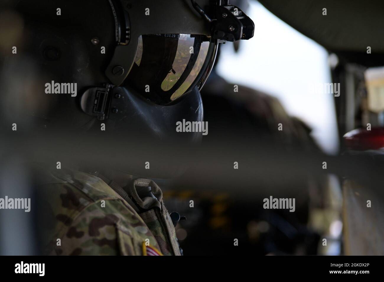 U.S. Army, UH-60 Black Hawk crew chief sits in helicopter during flight ...