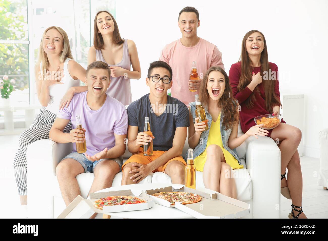 Friends watching TV at home Stock Photo - Alamy