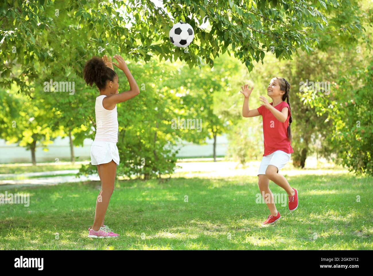 Cute children playing with ball in park Stock Photo - Alamy