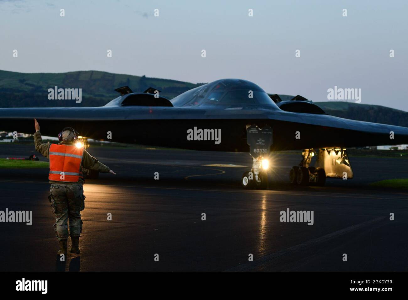 A crew chief assigned to the 393rd Expeditionary Bomb Squadron marshals ...