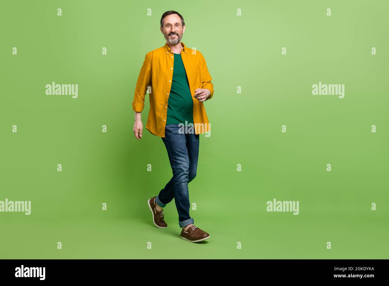 Full length photo of cheerful man happy positive smile go walk step ...