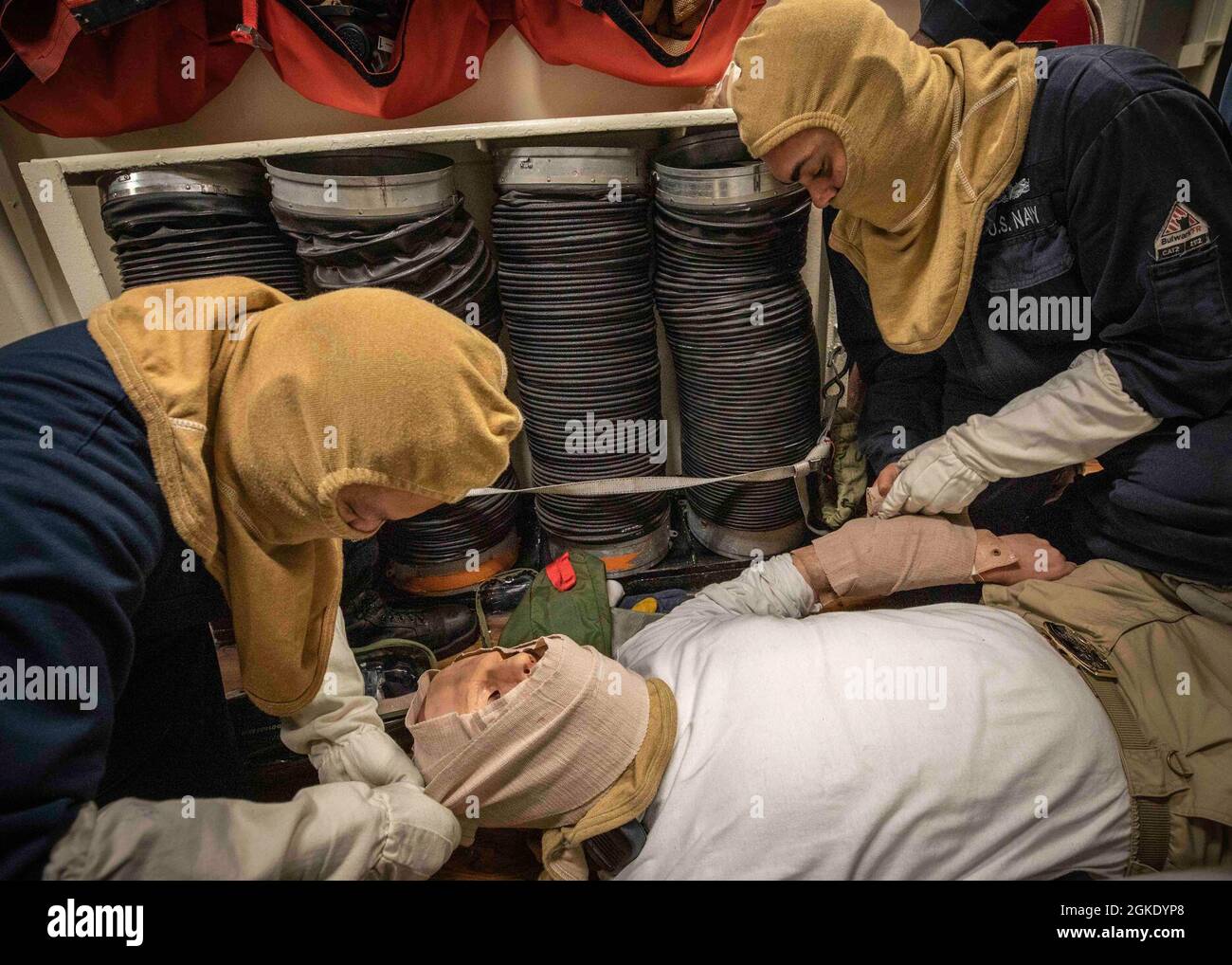 Personnel Specialist 1st Class Joseph Ferry treats a simulated head ...