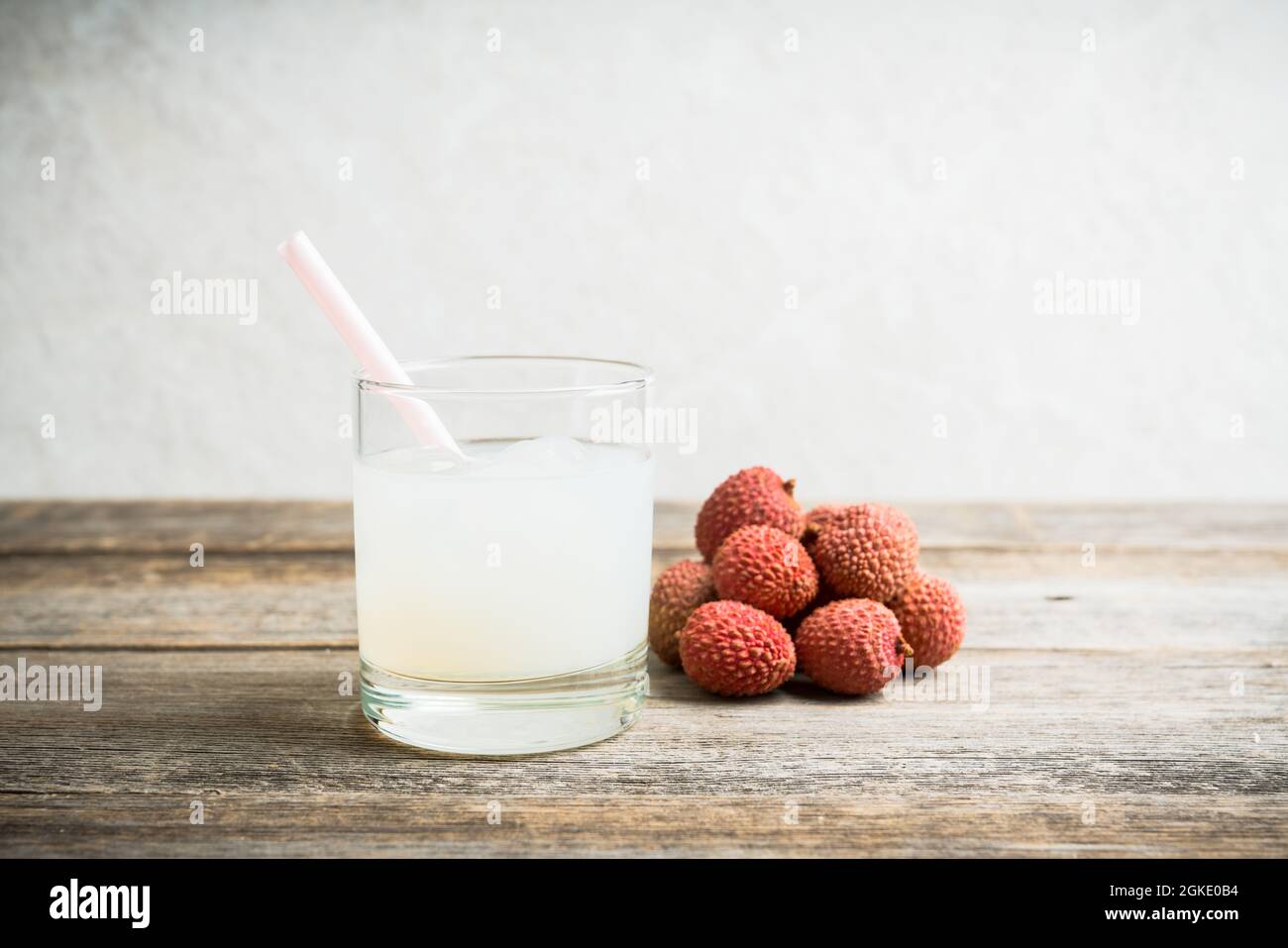 Old fashioned lychee cocktail on the rustic background. Selective focus ...