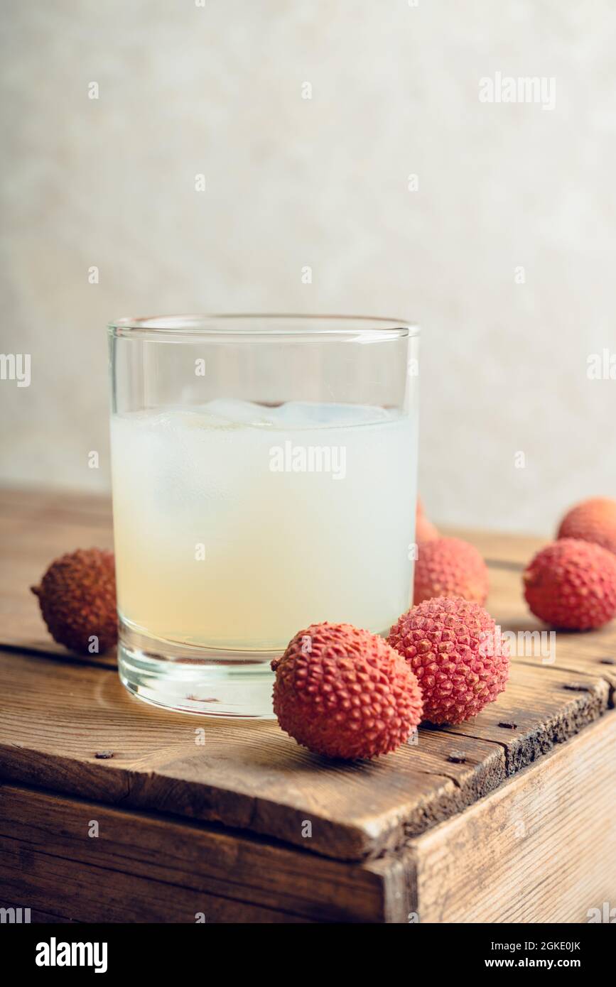 Old fashioned lychee cocktail on the rustic background. Selective focus ...