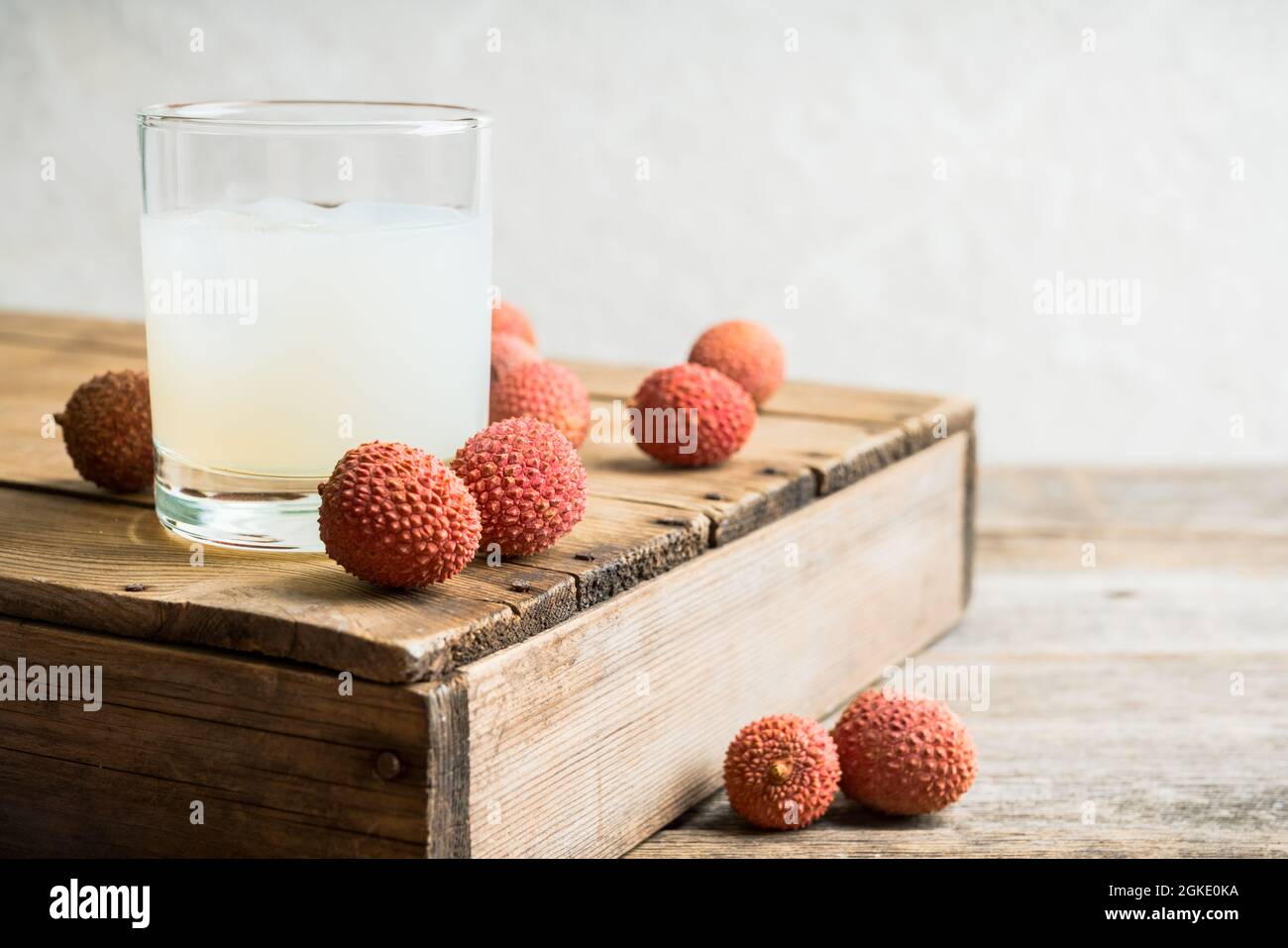 Old fashioned lychee cocktail on the rustic background. Selective focus ...