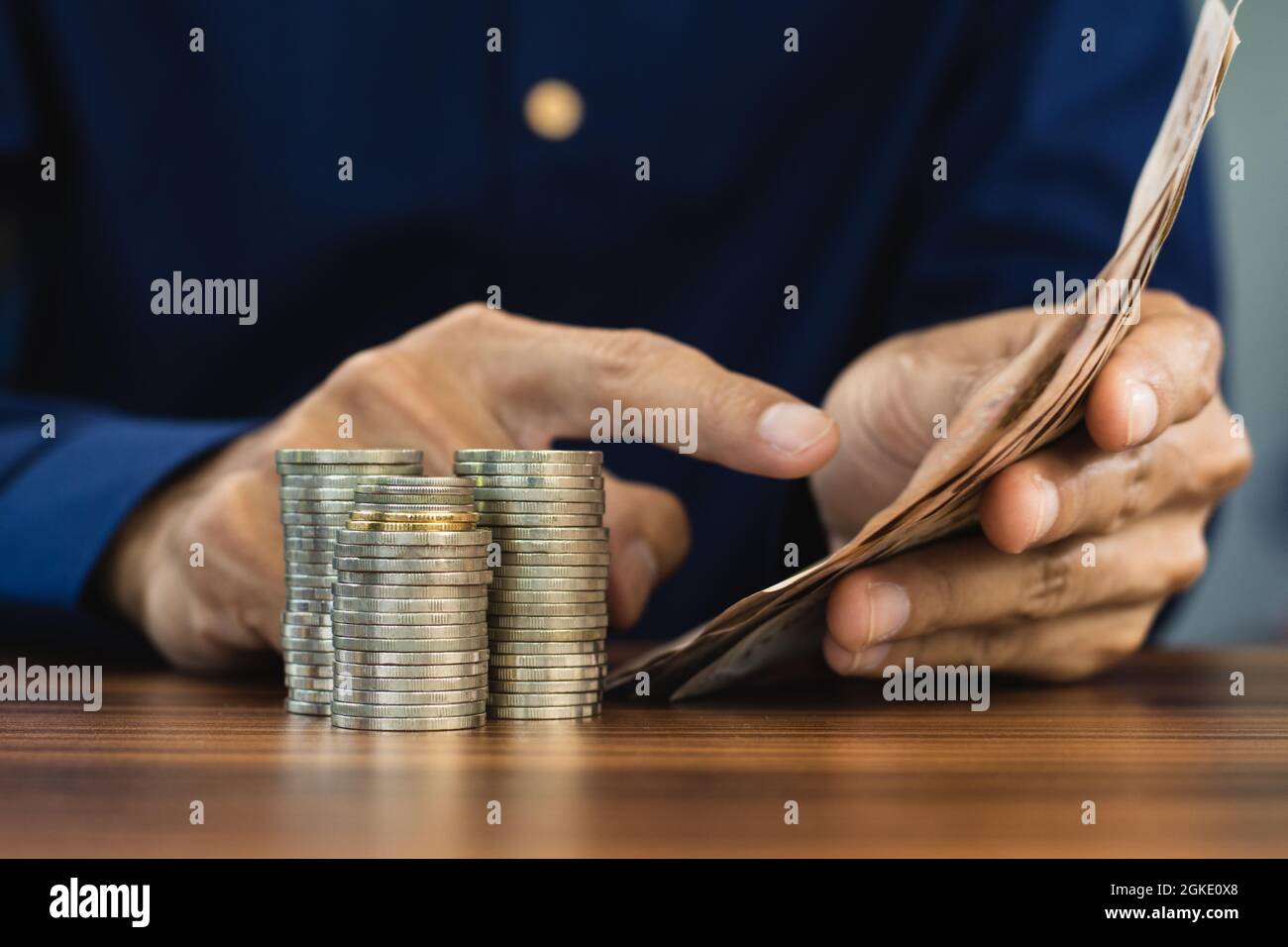 Hand counting money coins stack business finance Stock Photo - Alamy