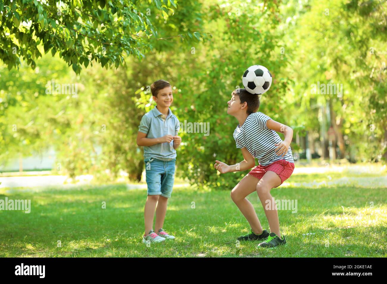 Cute children playing with ball in park Stock Photo - Alamy