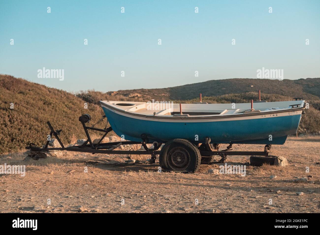 Blue boat on a barrow in the seashore Stock Photo - Alamy
