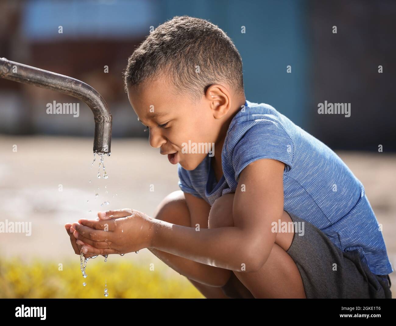 Poor Kid Drinking Water