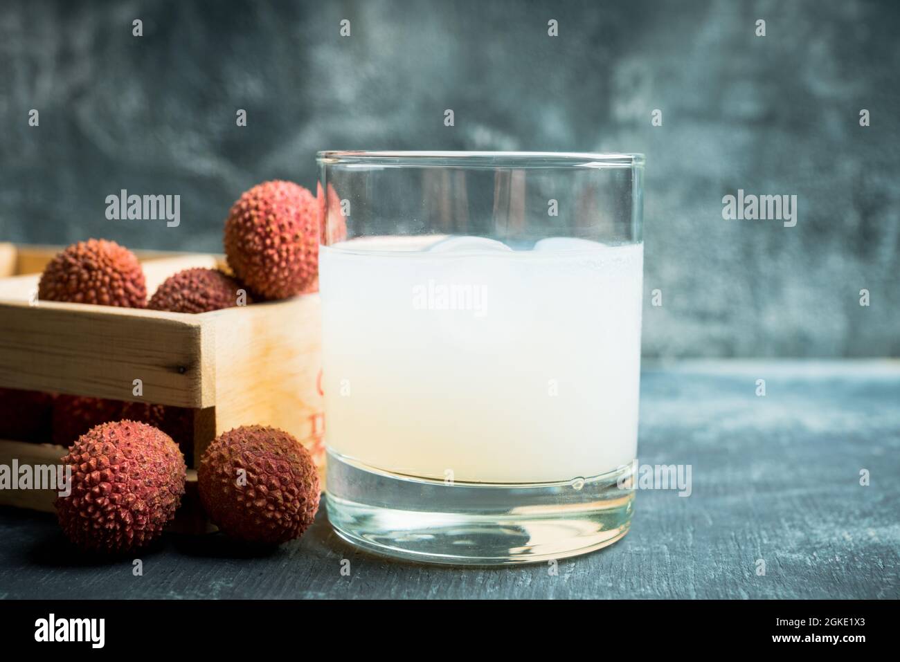 Old fashioned lychee cocktail on the rustic background. Selective focus ...