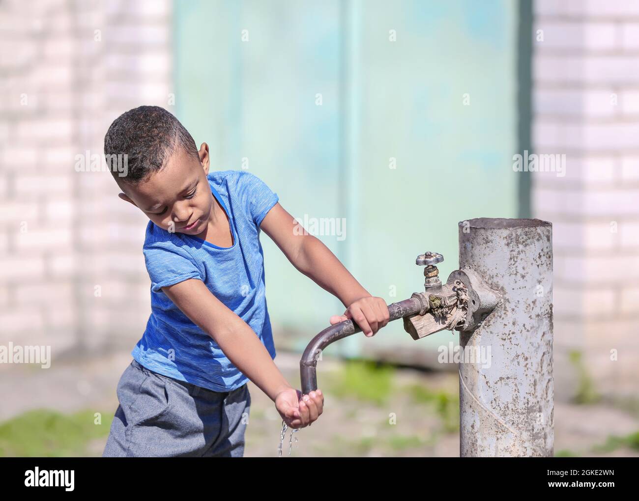 Boy drinking from tap africa hi-res stock photography and images - Alamy