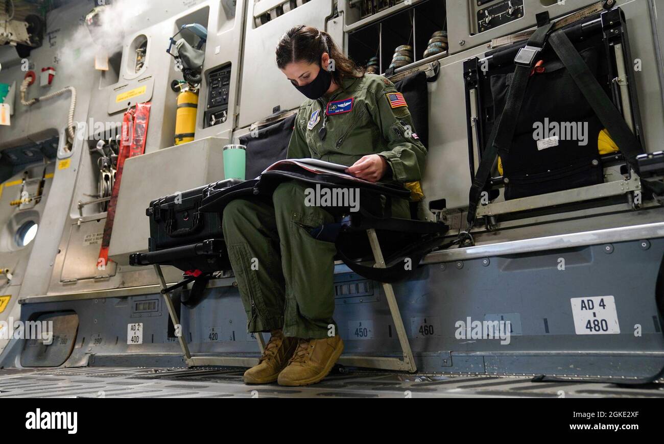 Maj. Cari Piha, 535th Airlift Squadron instructor pilot, reads over the ...