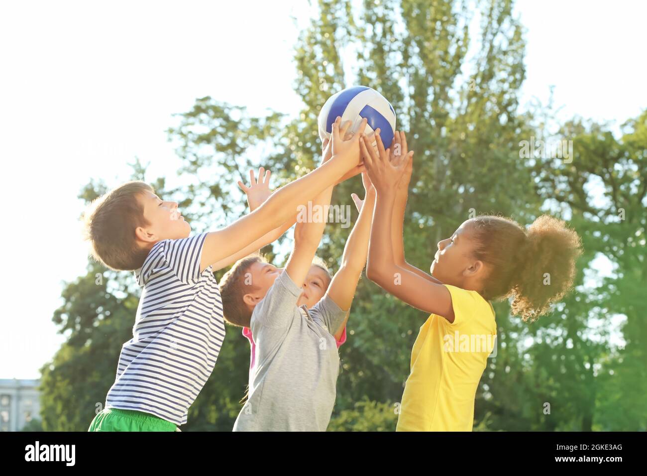 Cute children playing with ball outdoors Stock Photo - Alamy