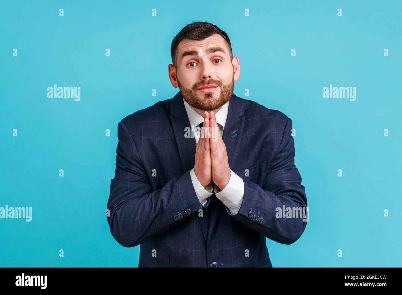 Please, I'm begging! Unhappy bearded man in official style suit keeping ...