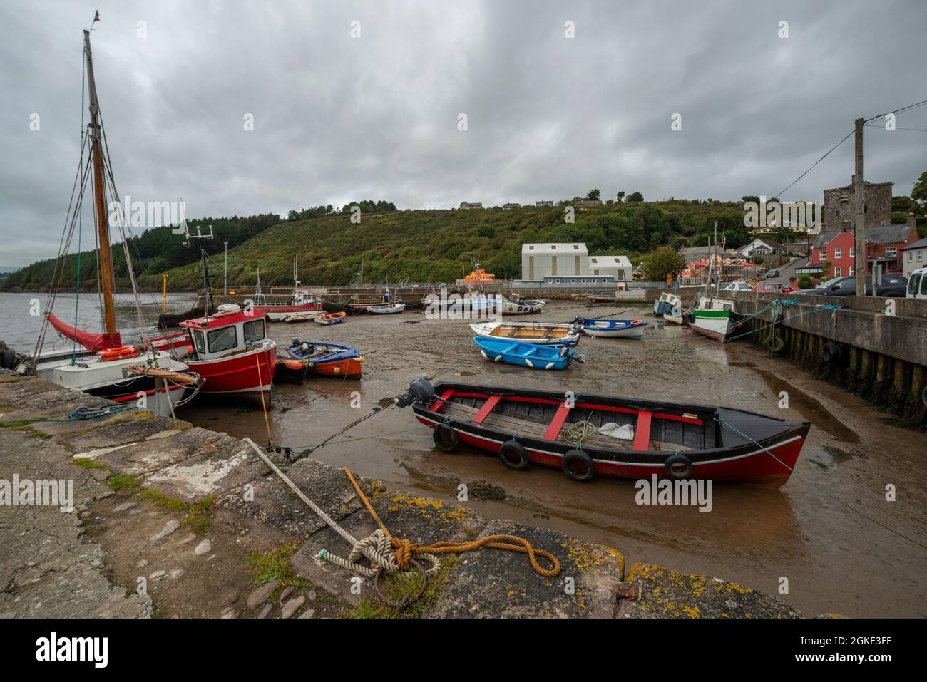 Boats stranded on the sand due to low tide in a small fishing port in ...