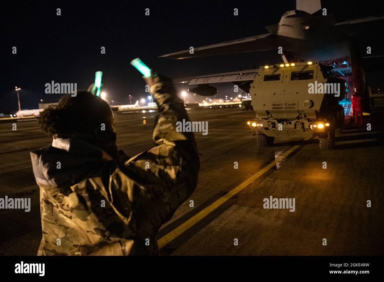 A loadmaster assigned to 352d Special Operations Wing assists marines ...