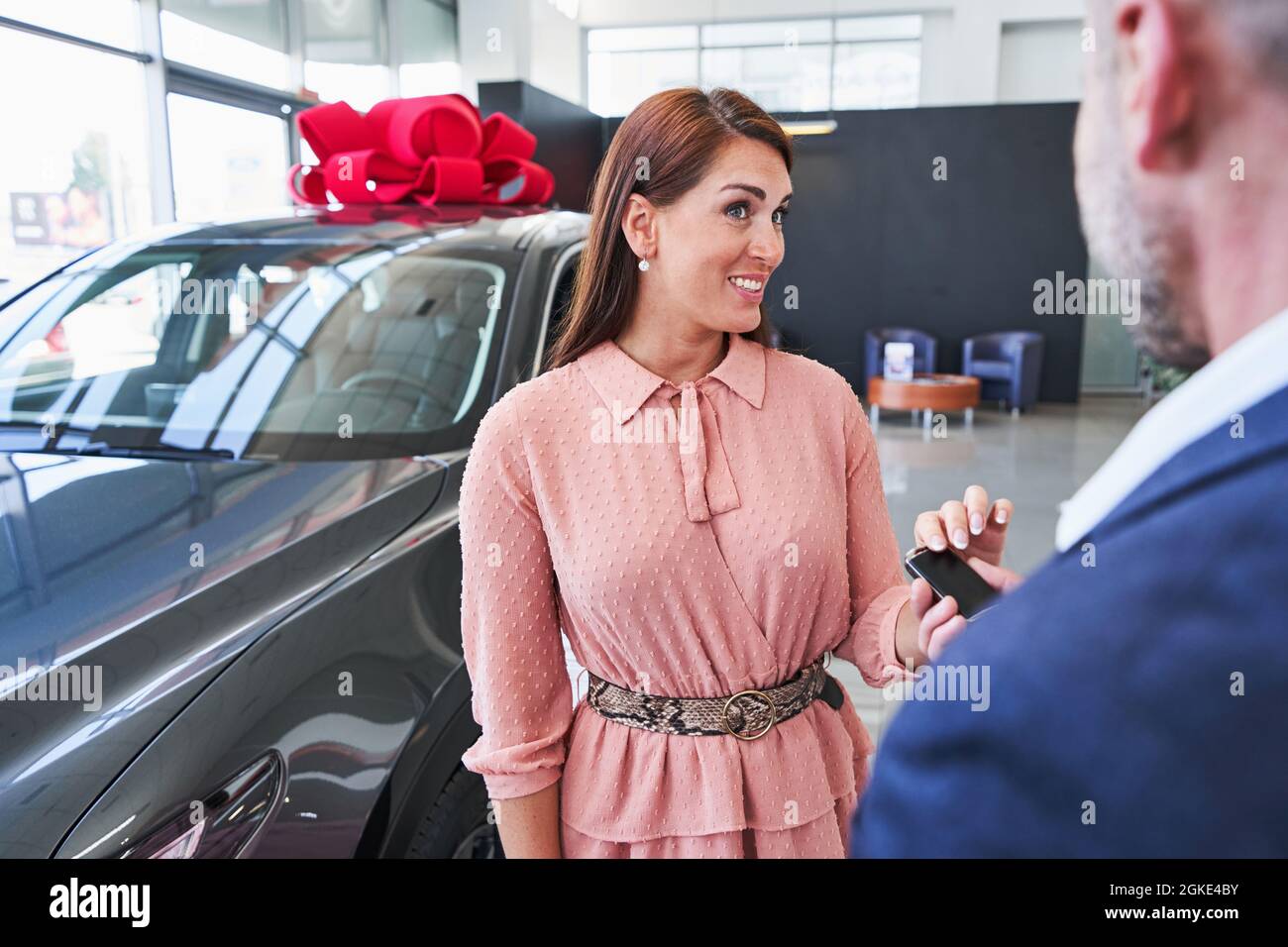 Smiling lady not believing the expensive gift Stock Photo - Alamy