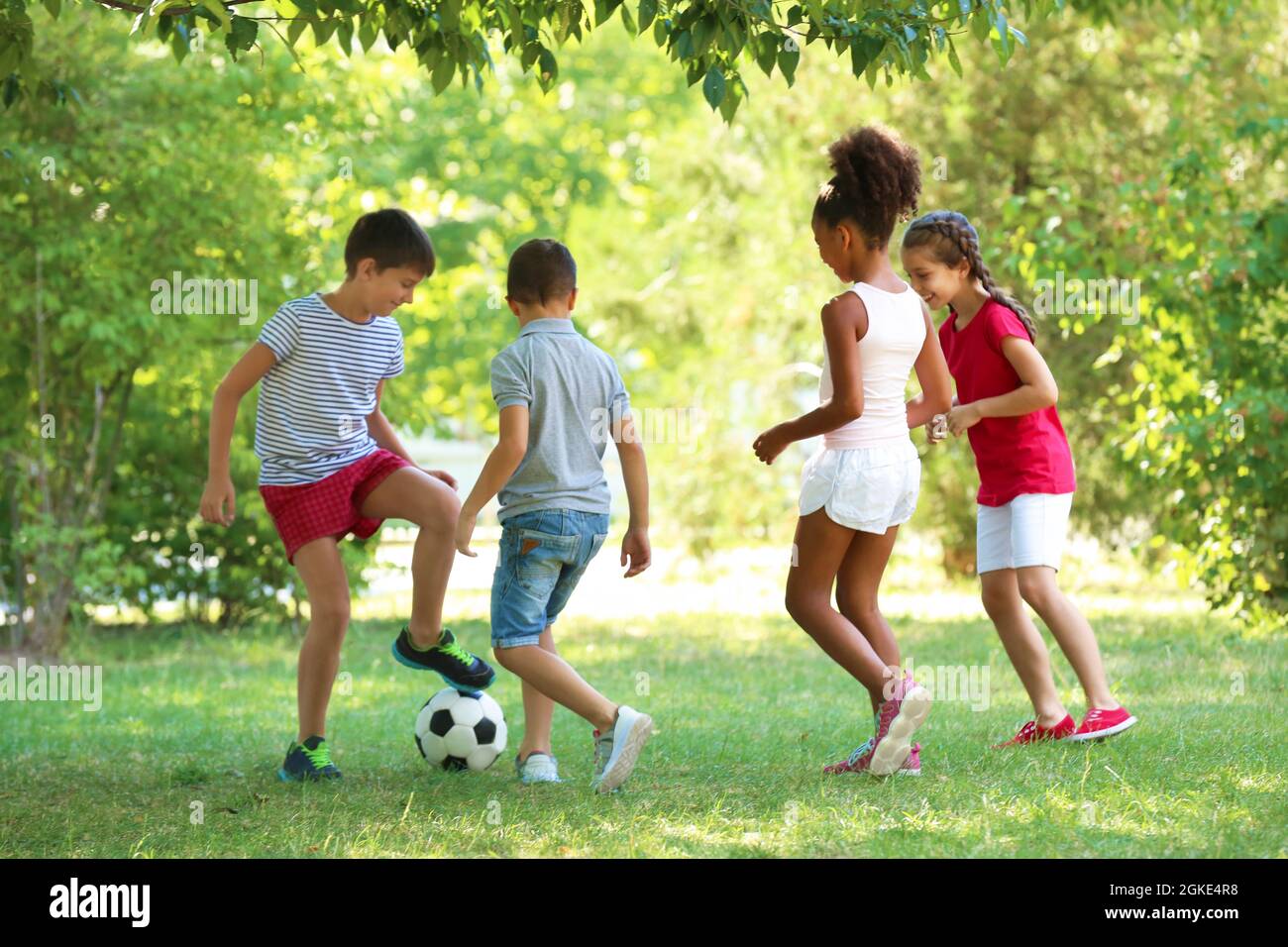 Kids Playing Soccer In The Park
